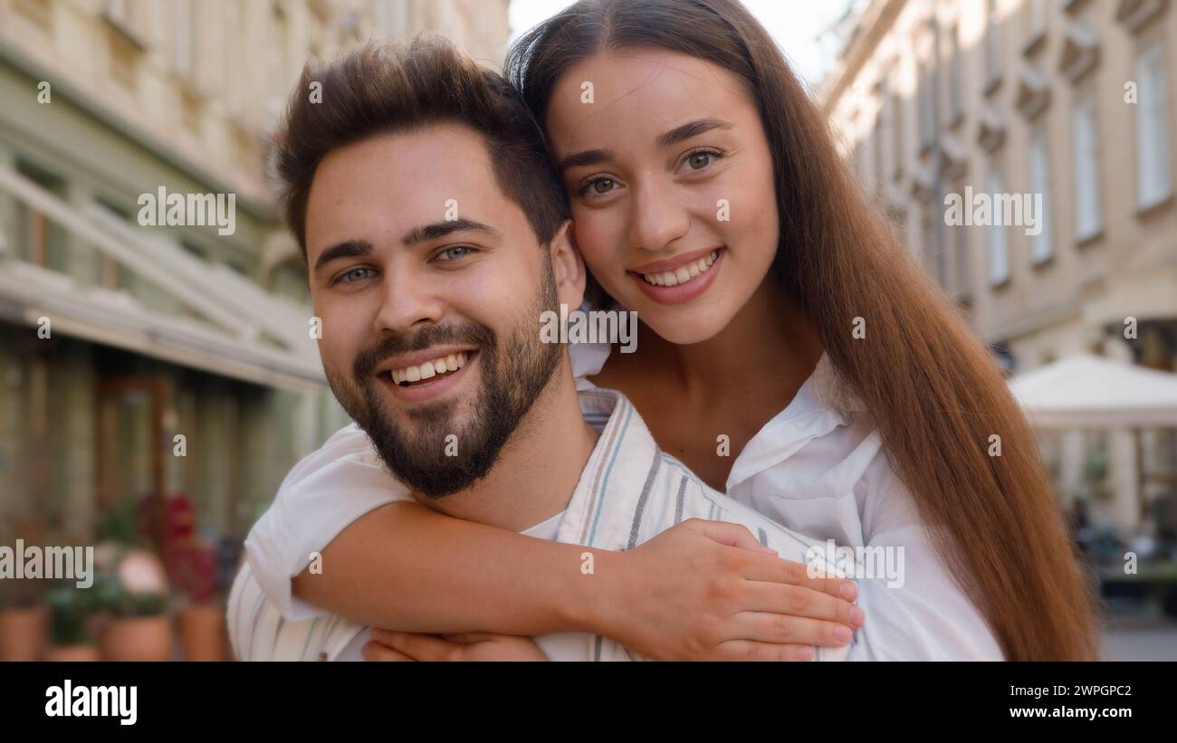 Happy young Caucasian couple man woman cuddling hugging hug embrace ...