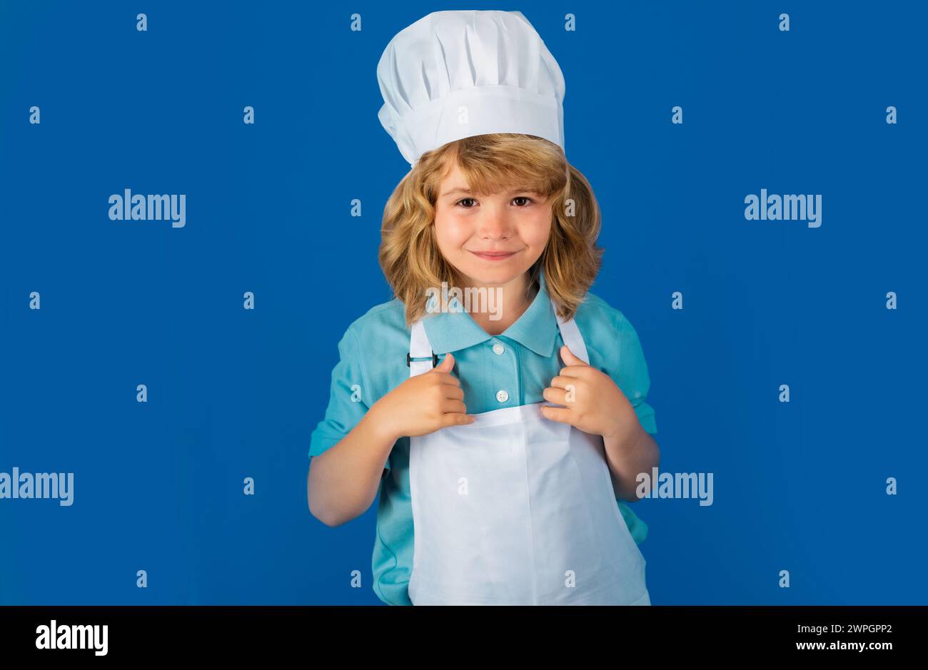 Chef funny face. Child wearing cooker uniform and chef hat Stock Photo ...