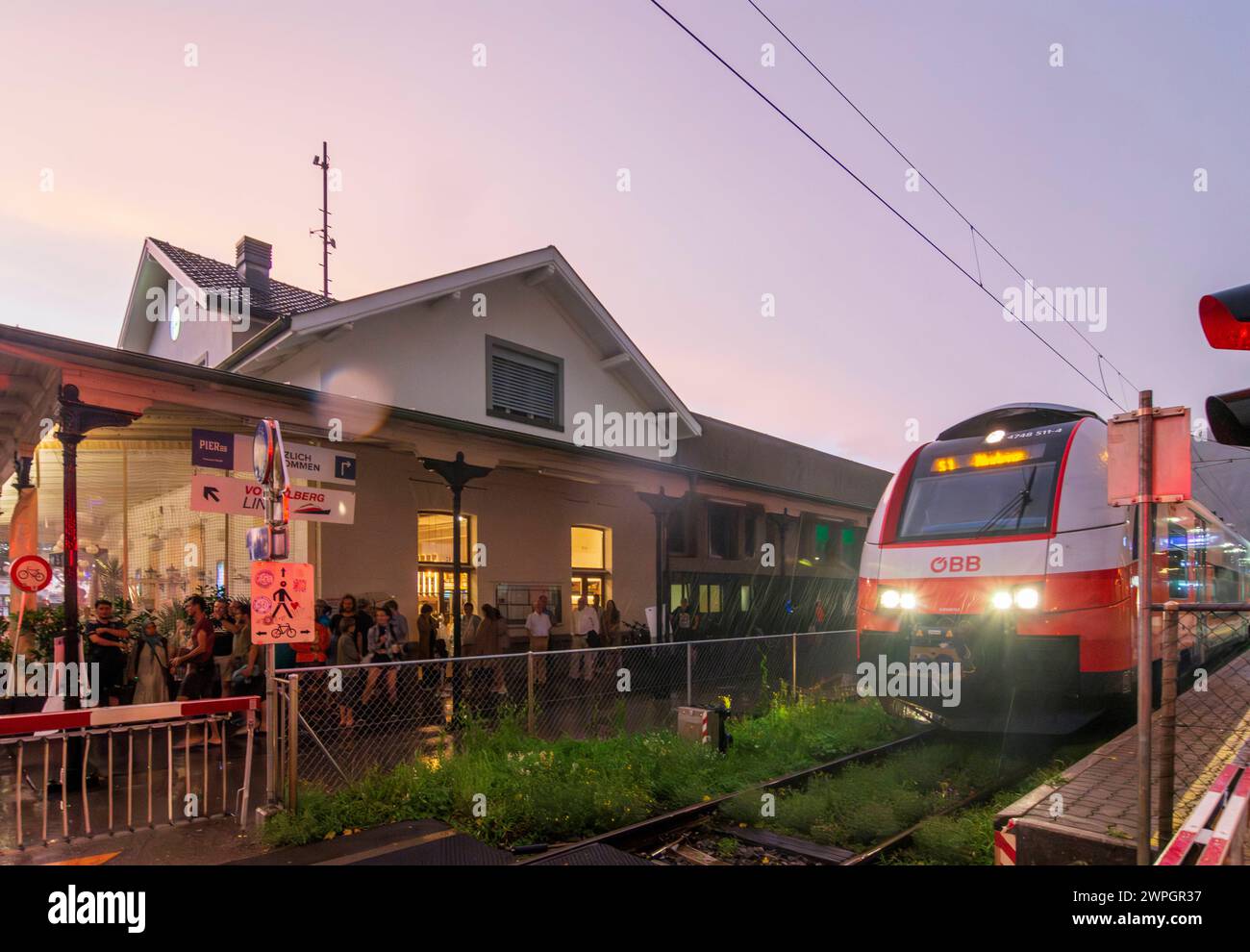 railway station Bregenz Hafen, S-Bahn train of ÖBB, railway crossing ...