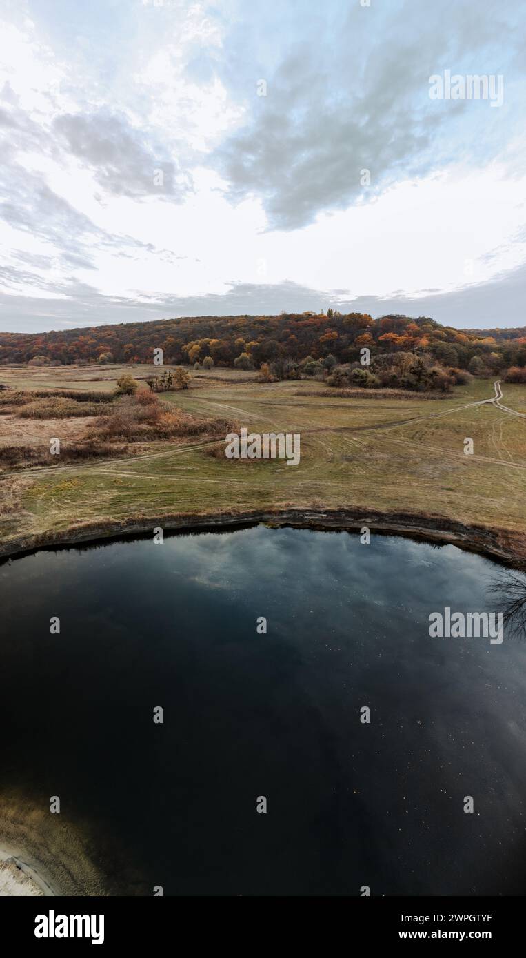 Aerial vertical panorama on deep river curve in autumn valley with ...