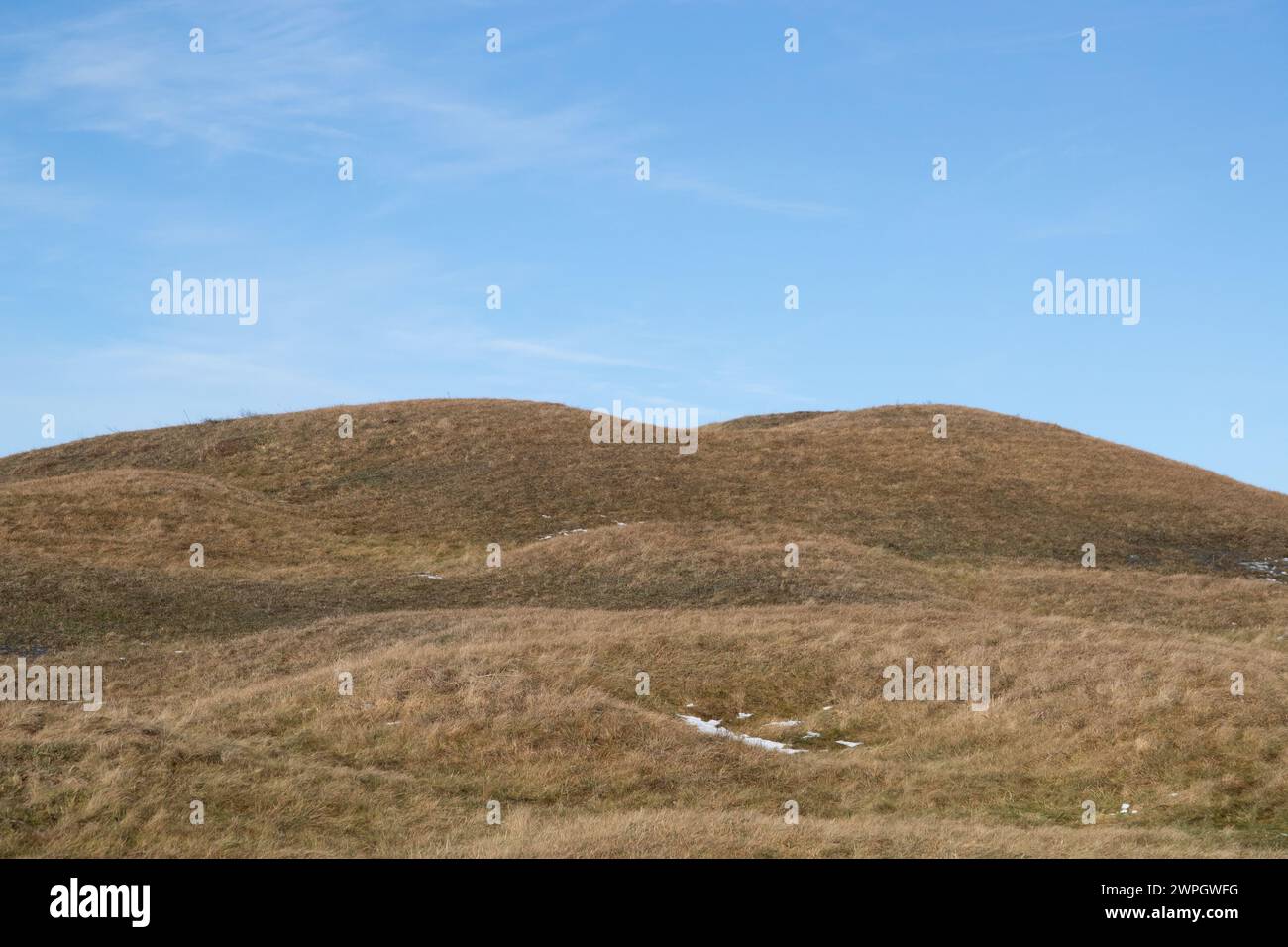 Burial mound covered with grass in rolling hill culture landscape ...