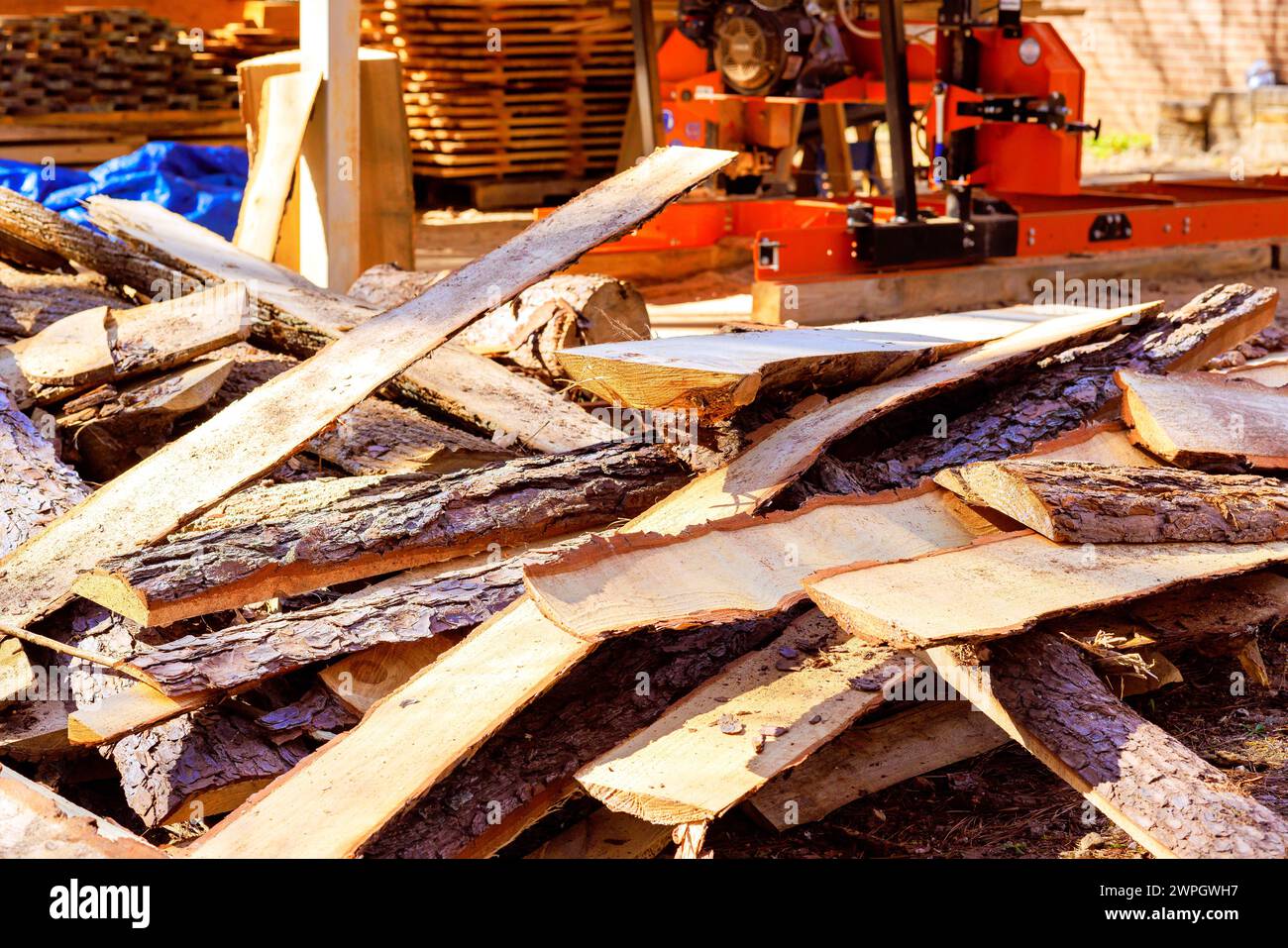 After sawing, wood scrap debris is stacked near sawmill Stock Photo - Alamy