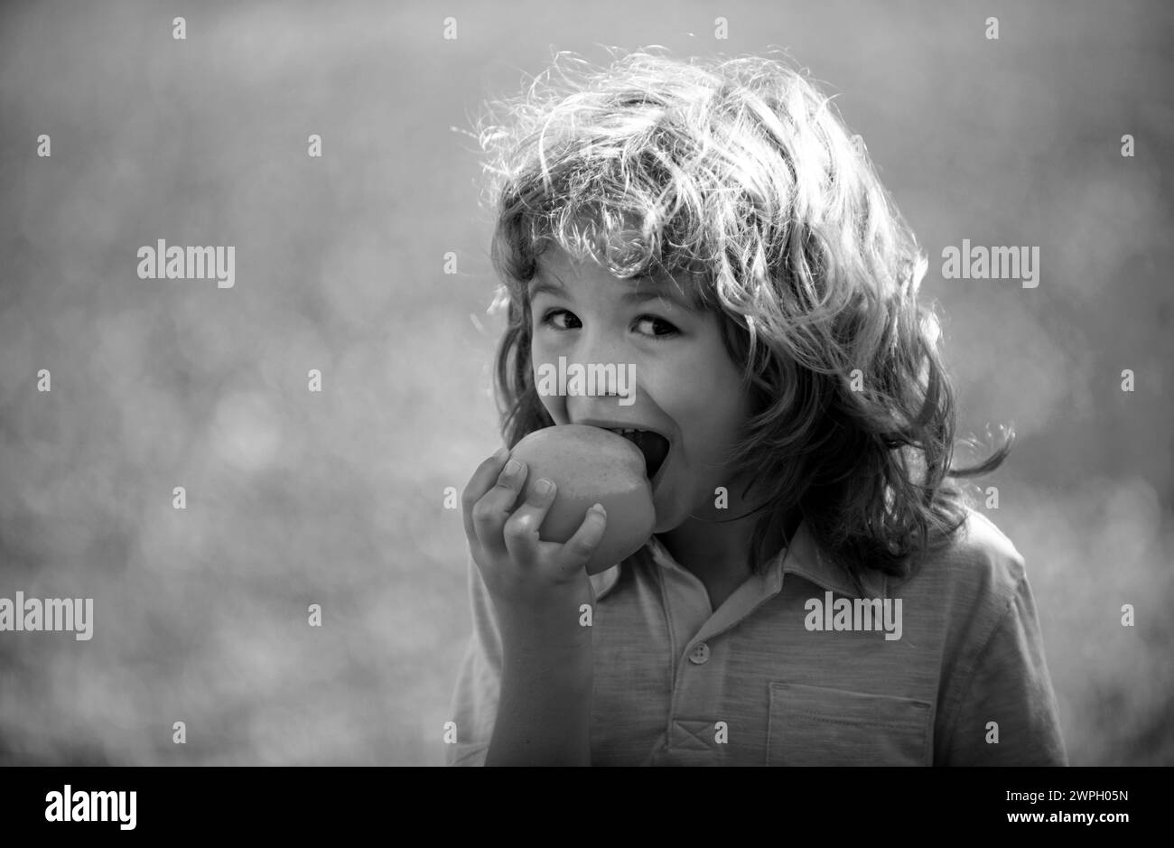 Little cute child eating green apple. Portrait of kid eating and biting ...