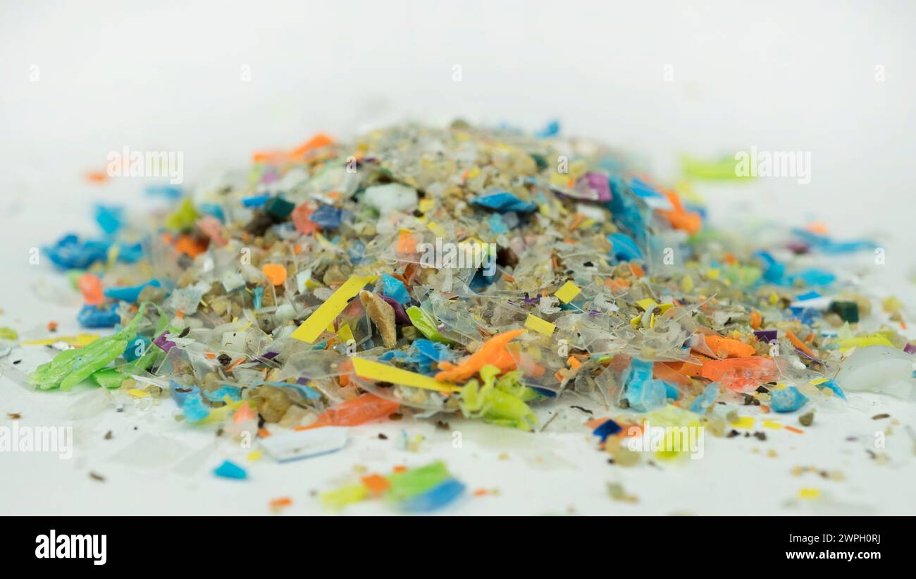 Macro shot on a pile of microplastics and sand collected from the beach ...