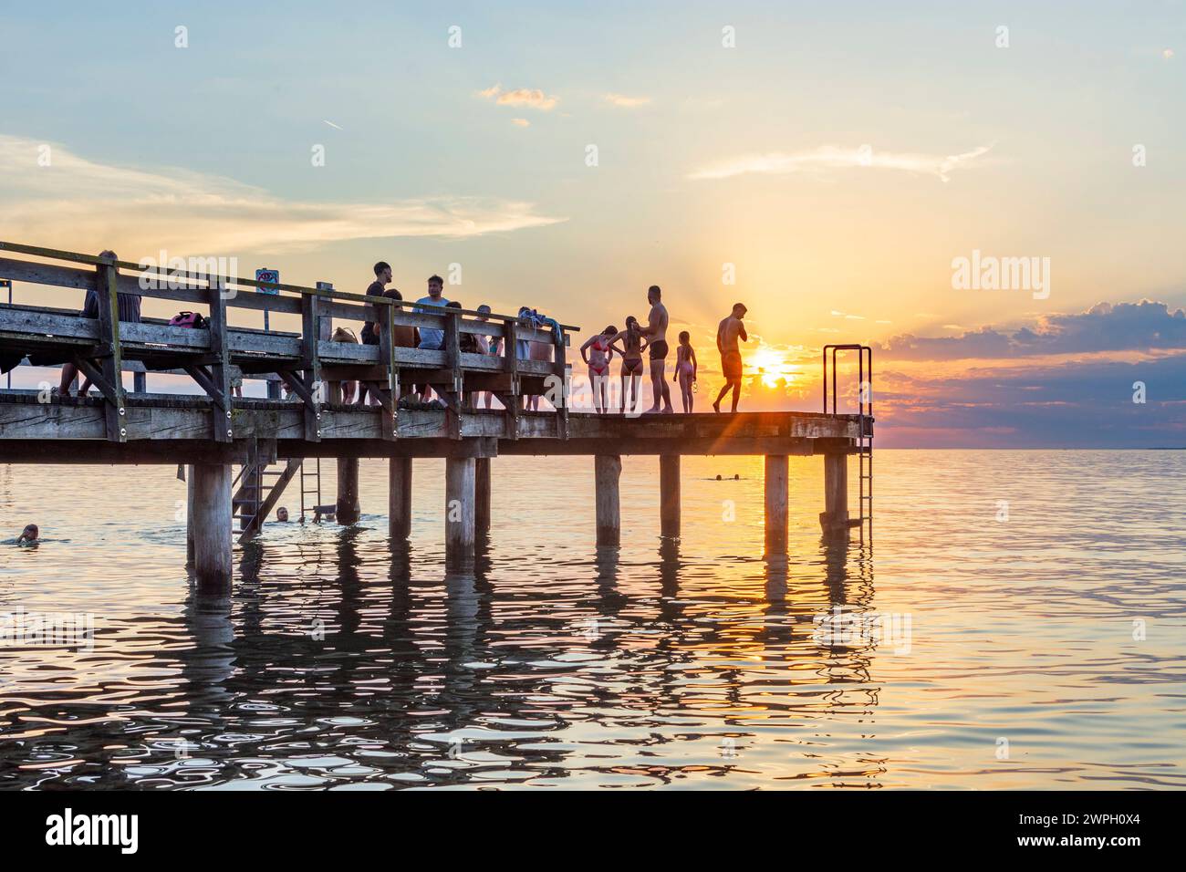 lake Bodensee Lake Constance, bathing jetty, bather, sunset Bregenz ...