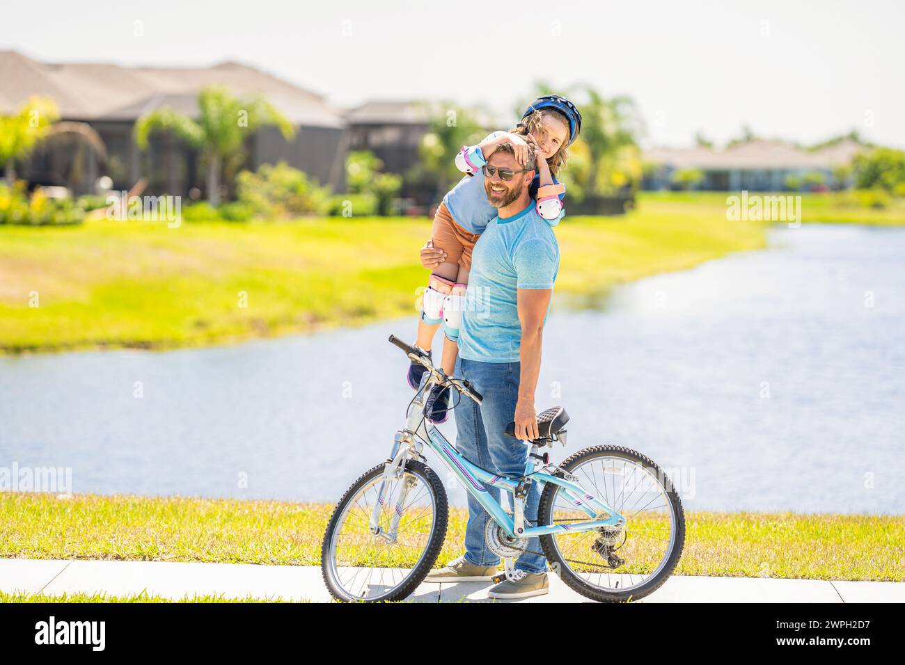 happy son and daddy cycling on bicycle. Nurturing family connections ...