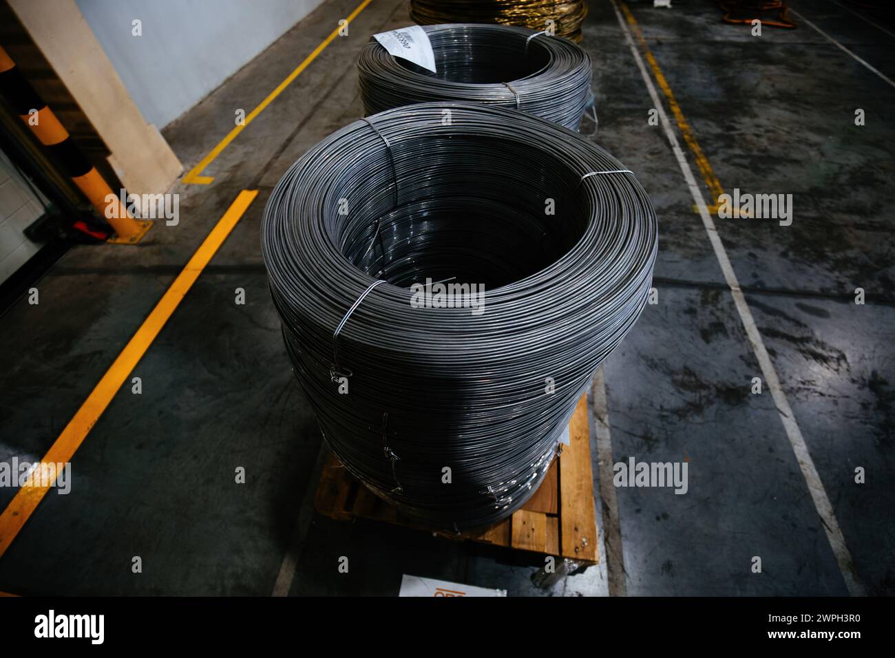 Steel wire coil in metalworking factory Stock Photo - Alamy