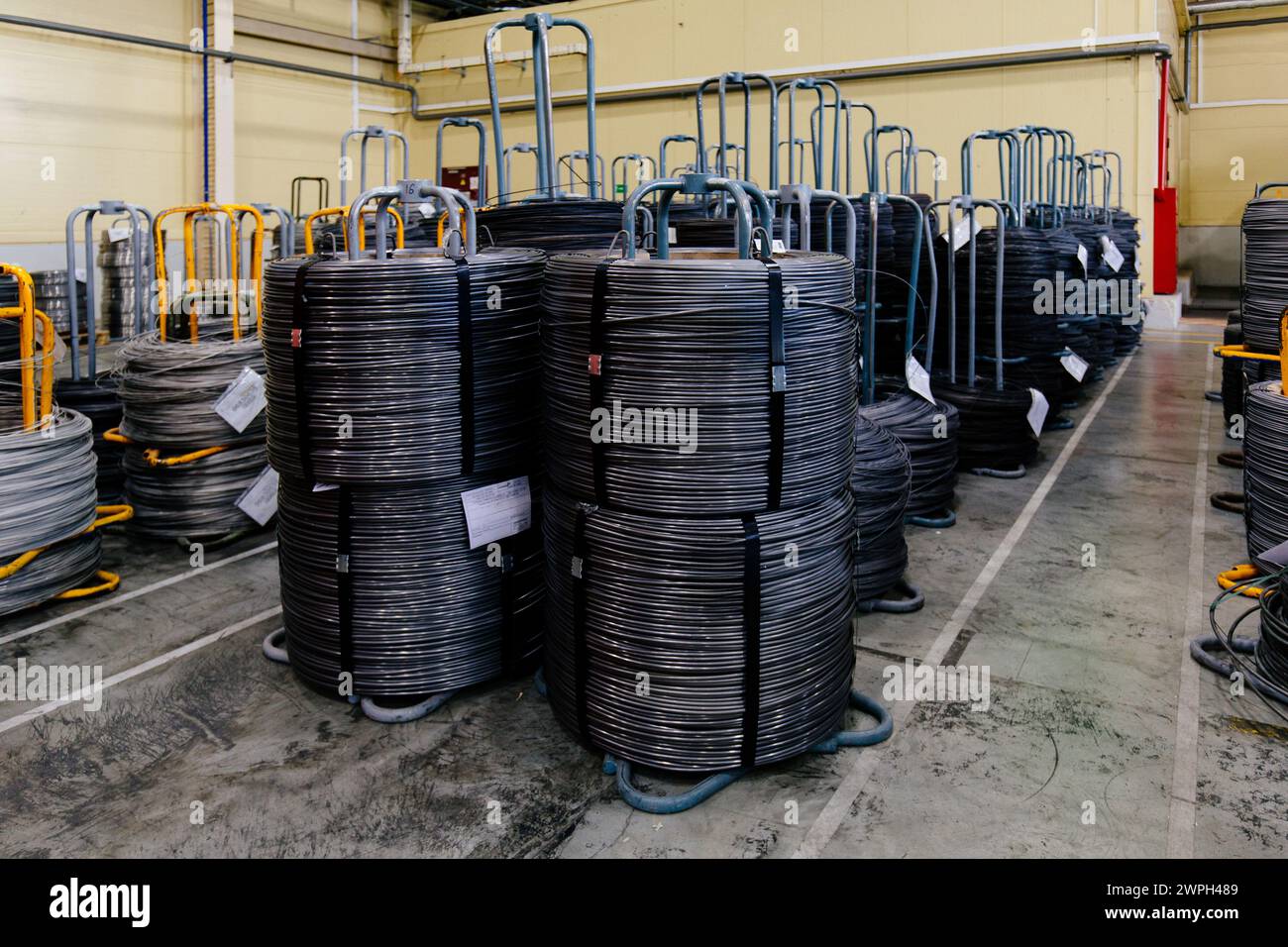 Steel wire coils in metalworking factory Stock Photo - Alamy