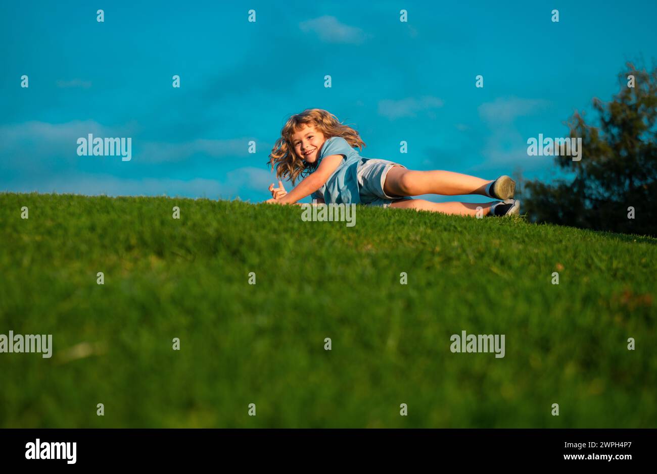 Boy falling down on grass. Kid falling off at the park Stock Photo - Alamy