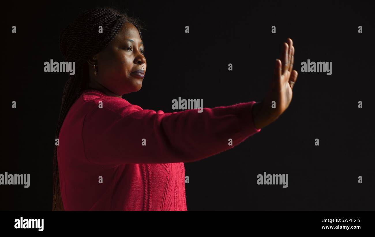 African american woman firmly signals stop using hand gesture in ...