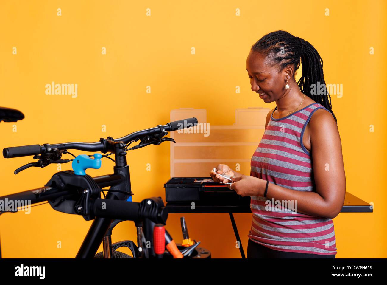Sports-loving woman choosing and examining different tools from ...