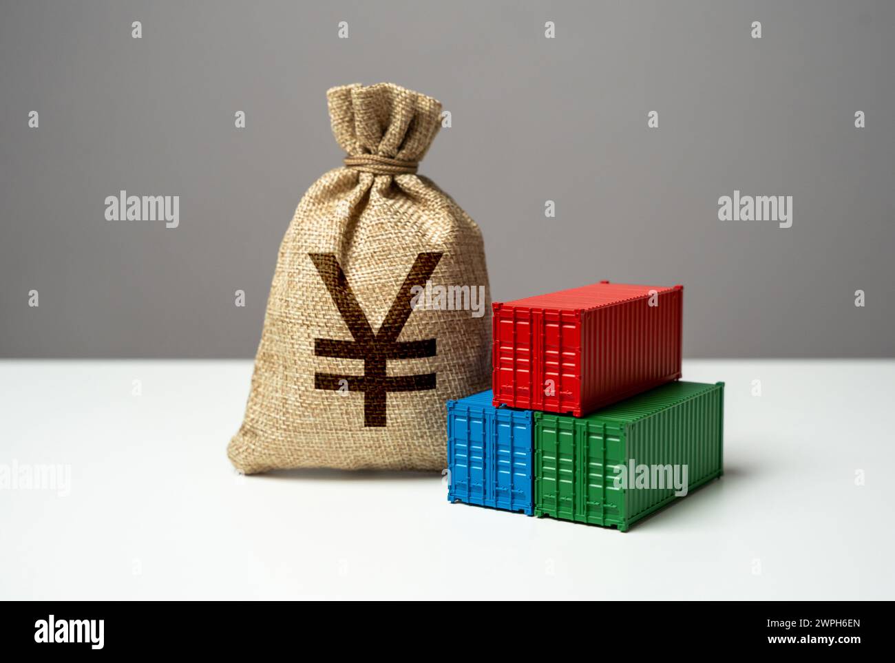 Stack of shipping containers and japanese yen money bag. Tariffs and ...