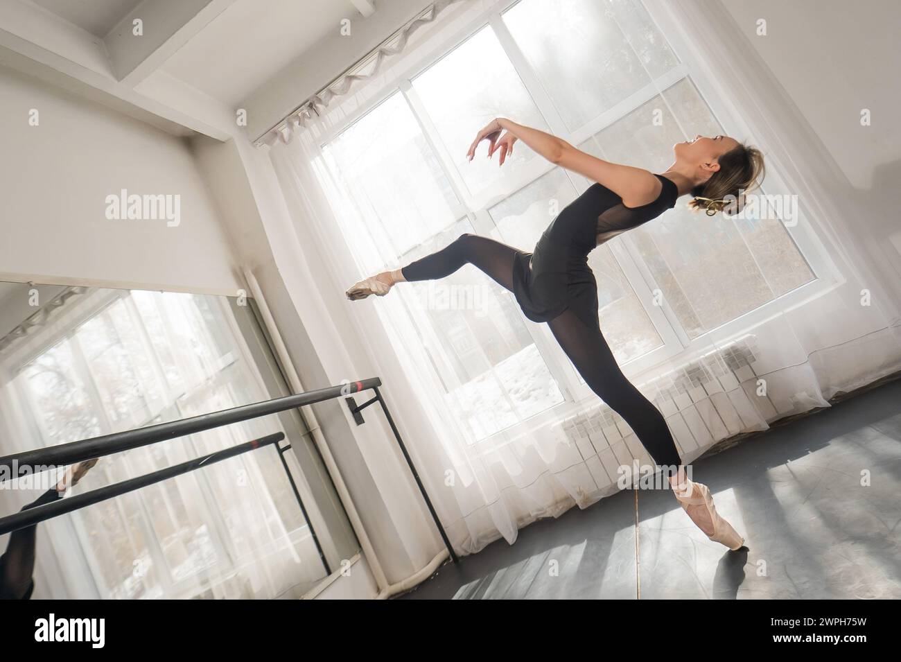 A beautiful Asian woman is dancing at the barre. Ballet dancer Stock ...