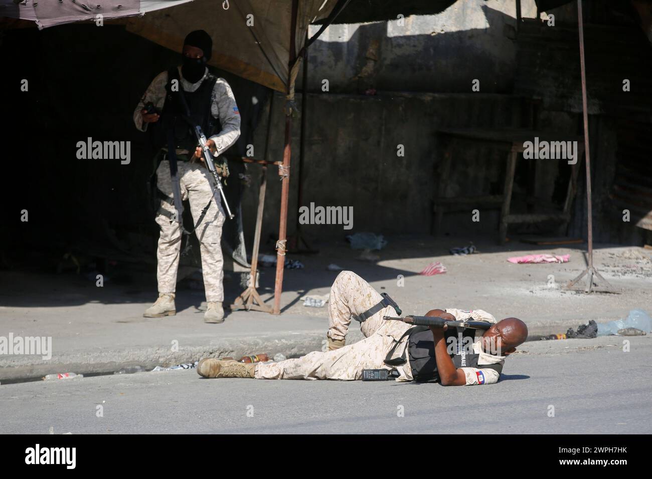 A police aims during clashes with gang members in Port-au-Prince, Haiti ...