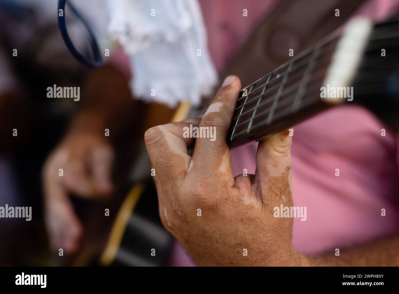Detail of hands playing a guitar with nylon strings. Professional ...