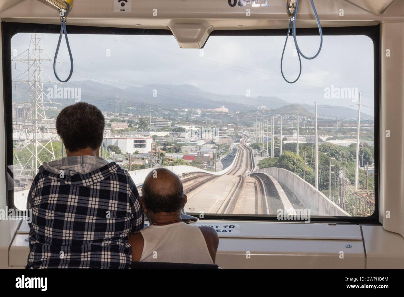 Honolulu, Hawaii, USA - February 24, 2024: Two local Hawaiins enjoying ...