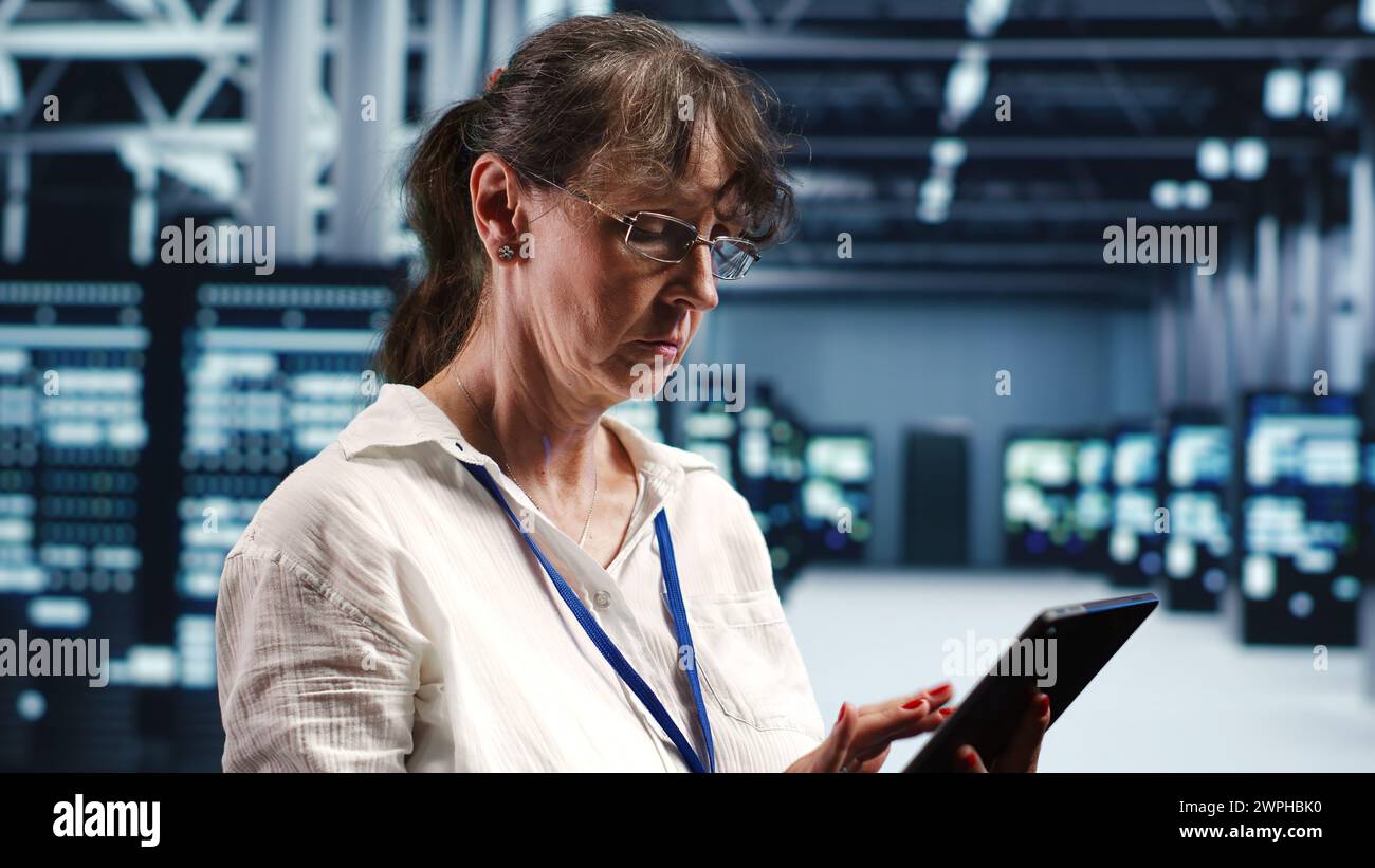 Elderly developer working in data center housing GPU dedicated server rows that can process ...