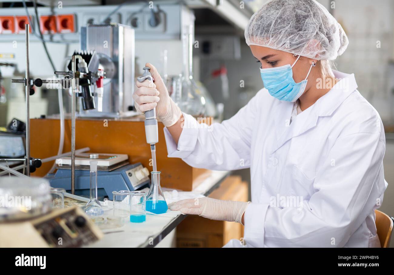 Female scientist mixing chemical solution hi-res stock photography and ...