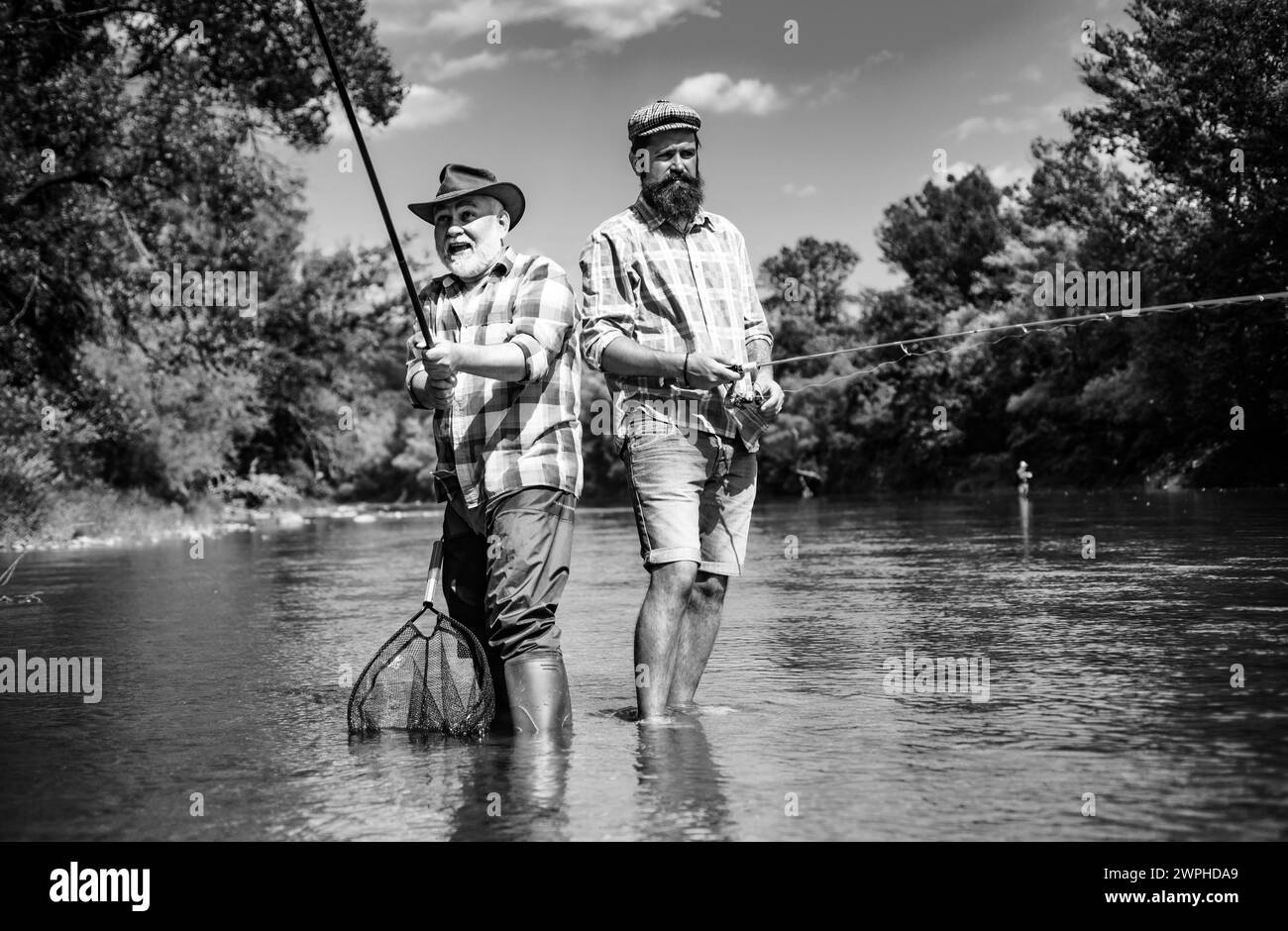 Two men friends fishing. Flyfishing angler makes cast, standing in ...