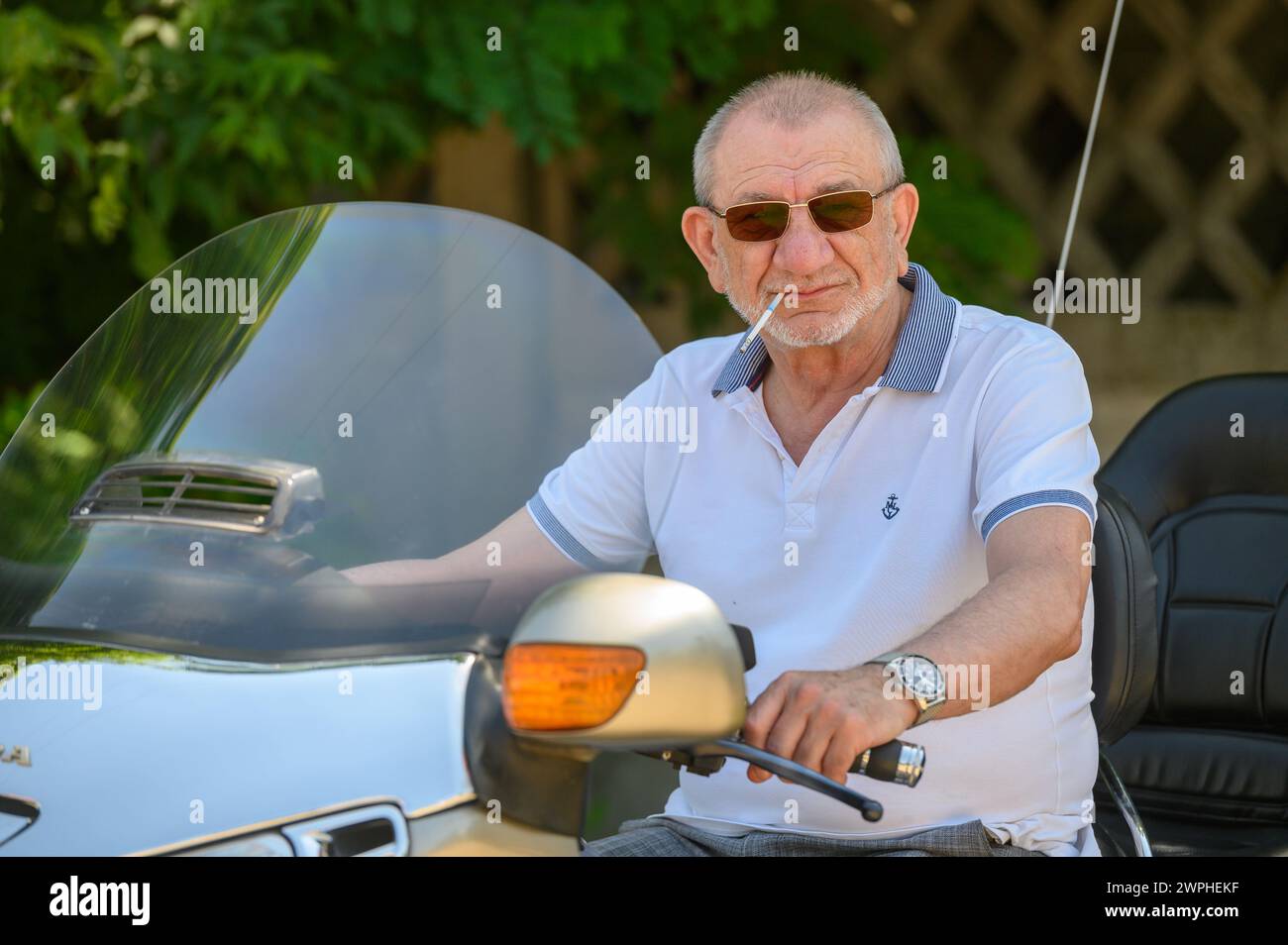 Elderly man sitting on motorcycle hi-res stock photography and images ...