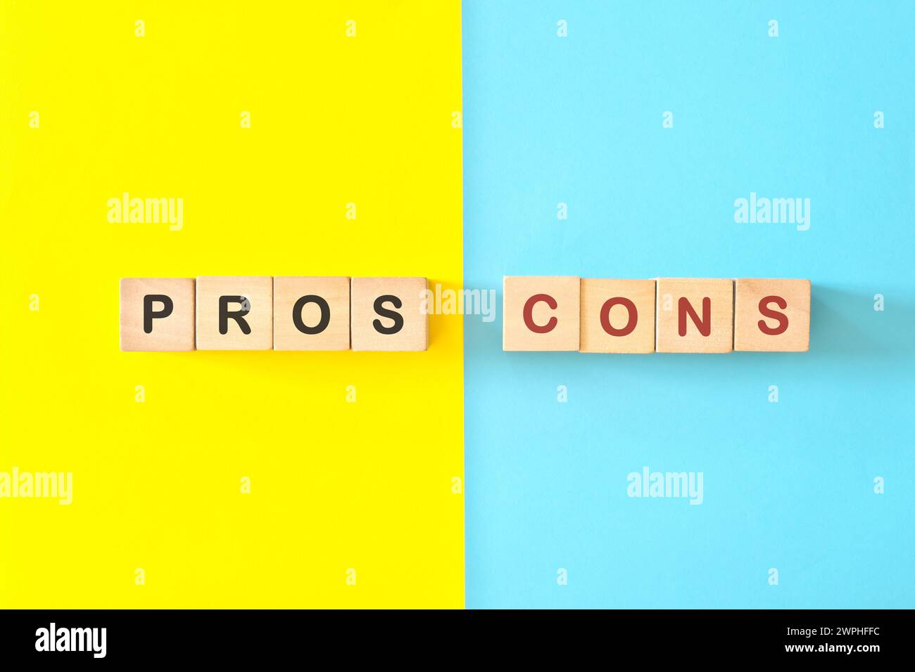 Pros and Cons concept. Wooden blocks typography in bright blue and ...