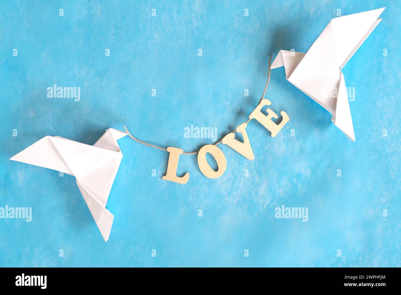 Spread message of love concept. Two white dove origami carrying word ...