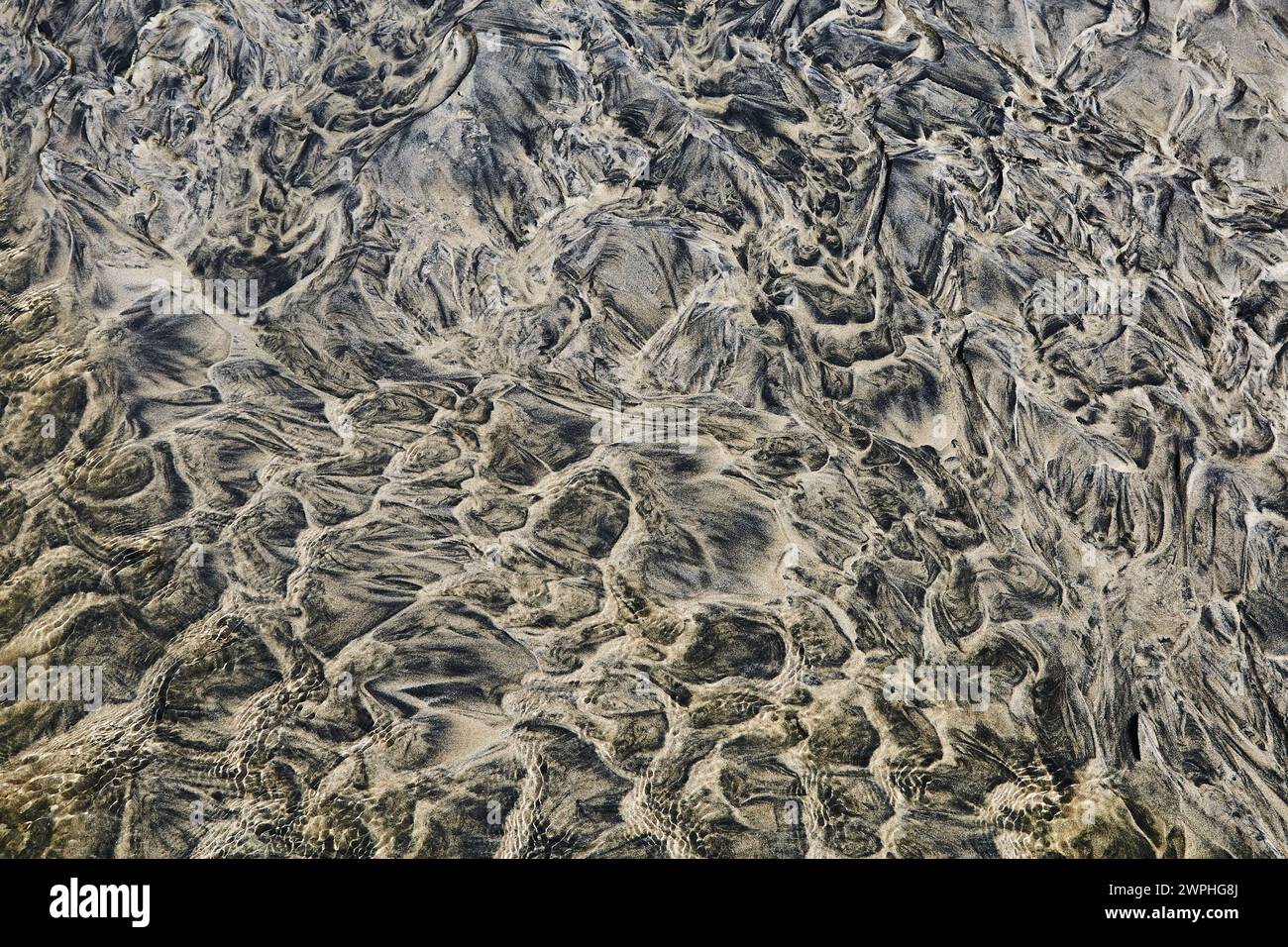 Wet sand and water strange, dark, abstract patterns Stock Photo - Alamy
