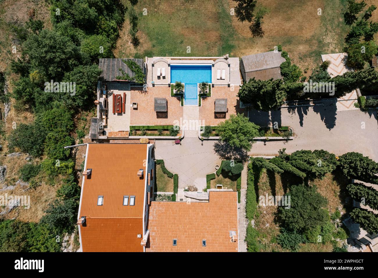 Ancient villa with a swimming pool in a green garden and sun loungers ...