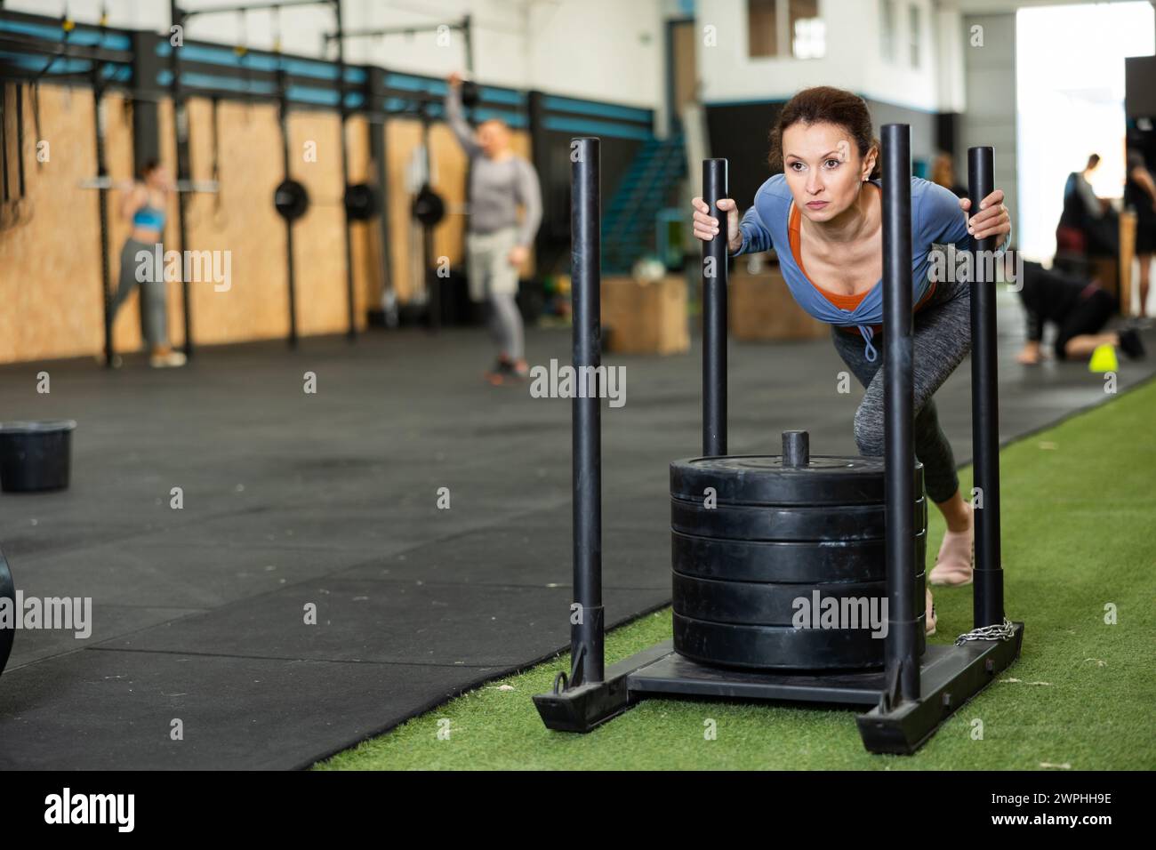 Woman during grueling workout with element of push and pull superset in ...