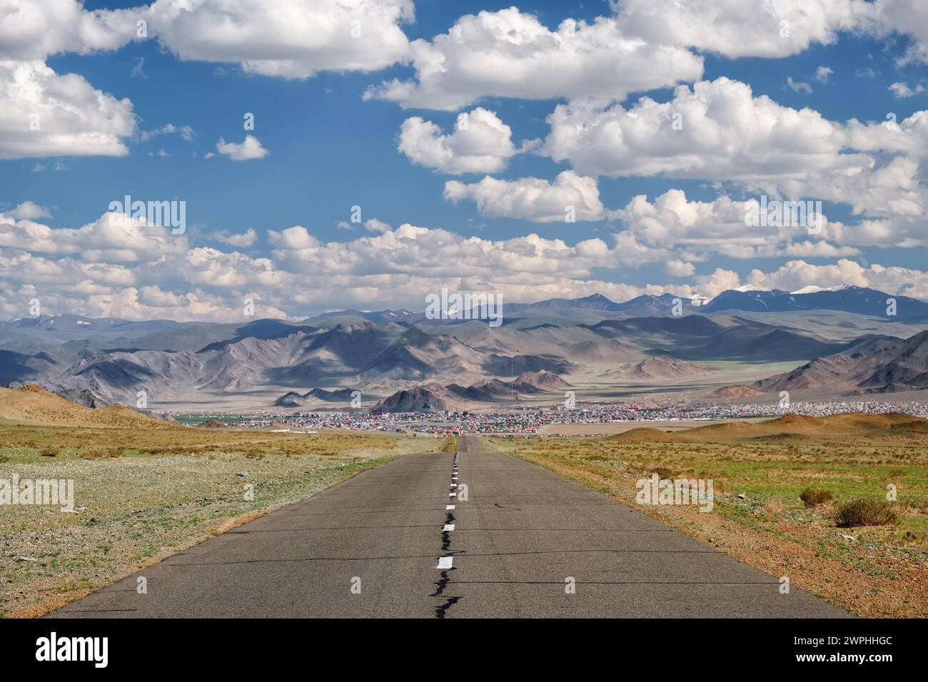 Empty Asphalt road in Mongolia with mongolian town Bayan-Olgii (Bayan ...