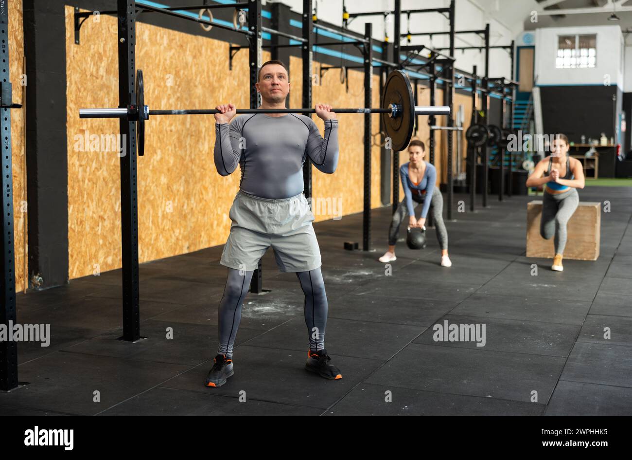 Adult male bodybuilder performing strength and endurance exercises ...