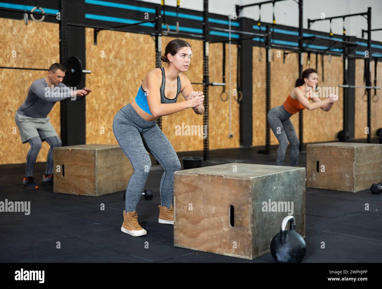 Girl performs exercises squats, hill climbing, kettlebell squats using ...
