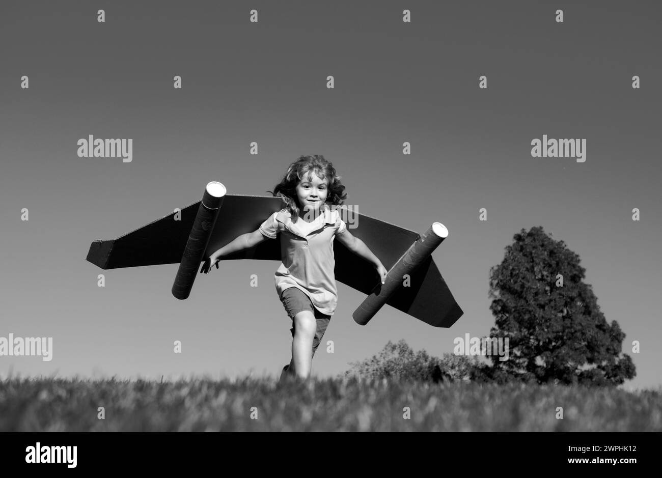 Boy child with wings at sky imagines a pilot and dreams of flying. Kids ...