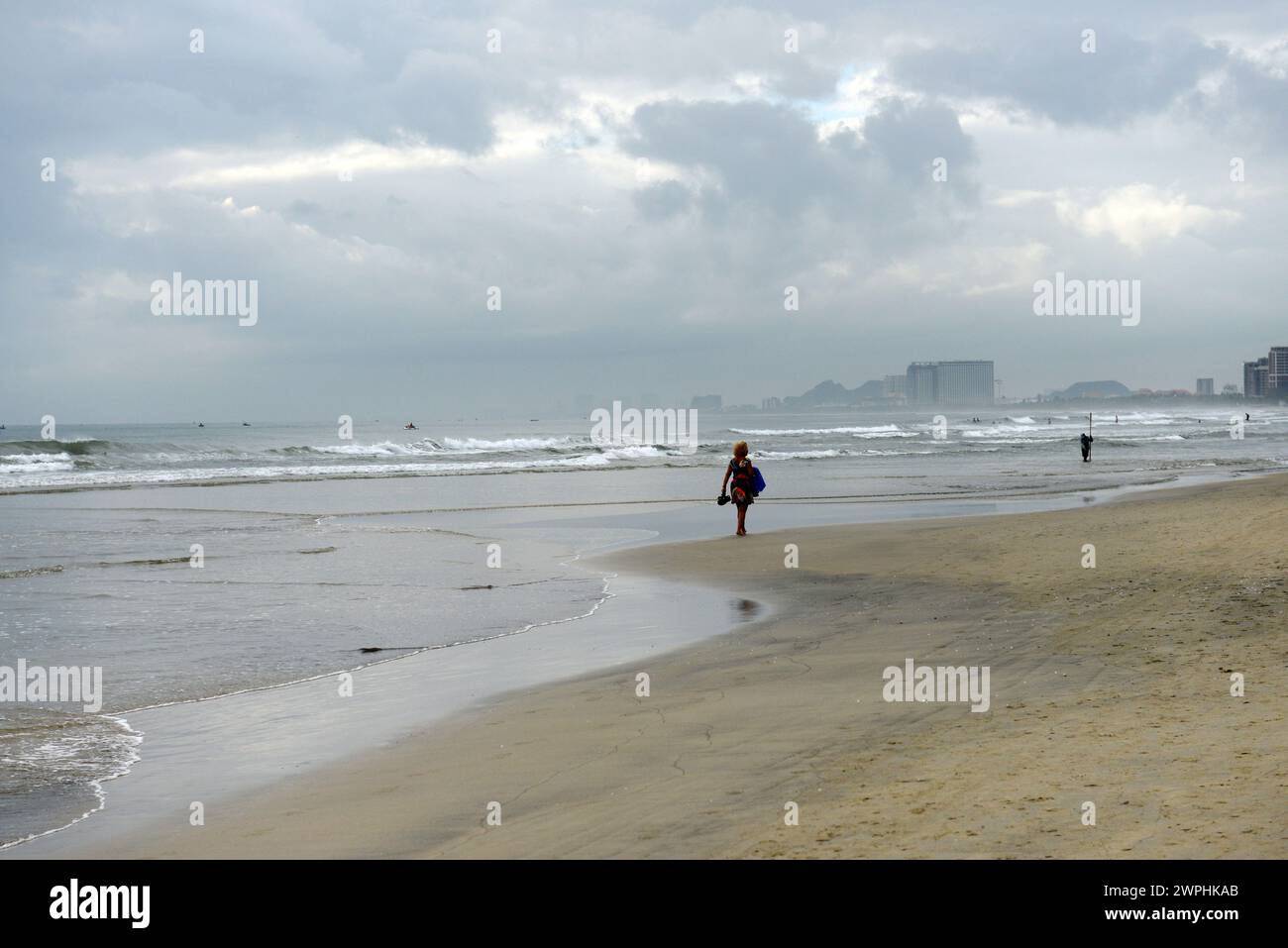 The beautiful long white sand beach along the changing waterfront ...