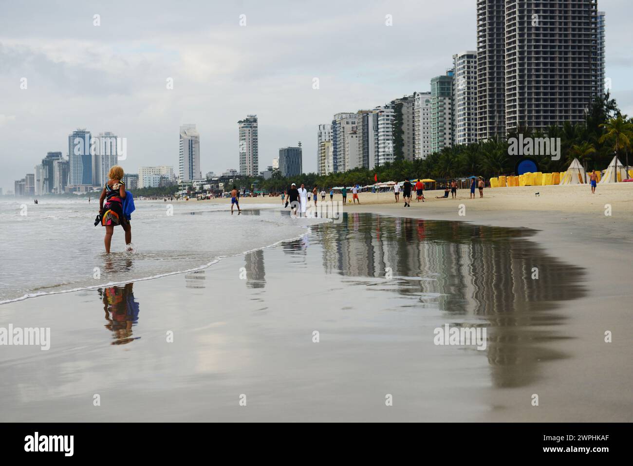 The beautiful long white sand beach along the changing waterfront ...