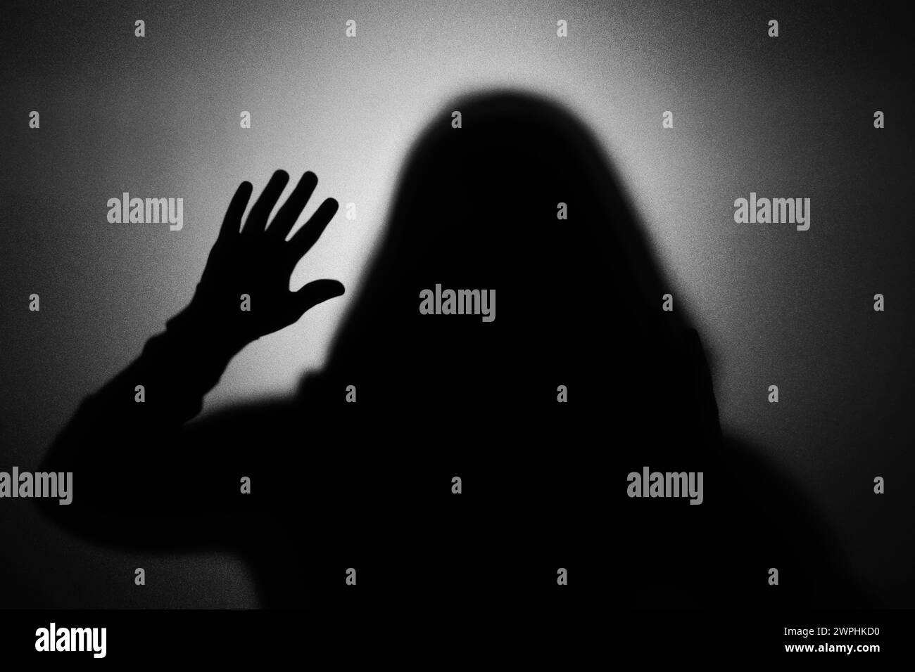 Silhouette of ghost behind glass against light grey background Stock ...