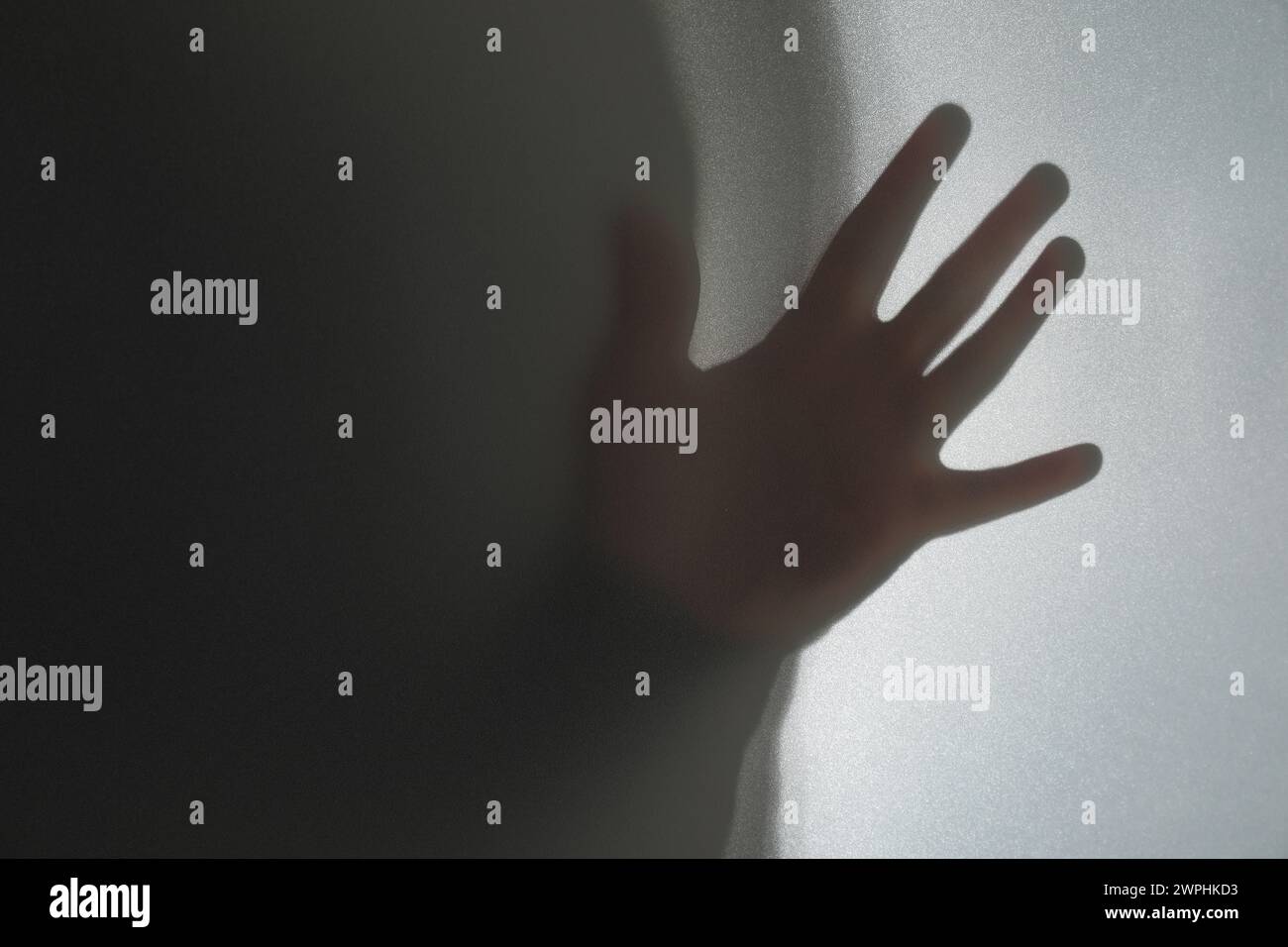 Silhouette of ghost behind glass against white background, closeup ...