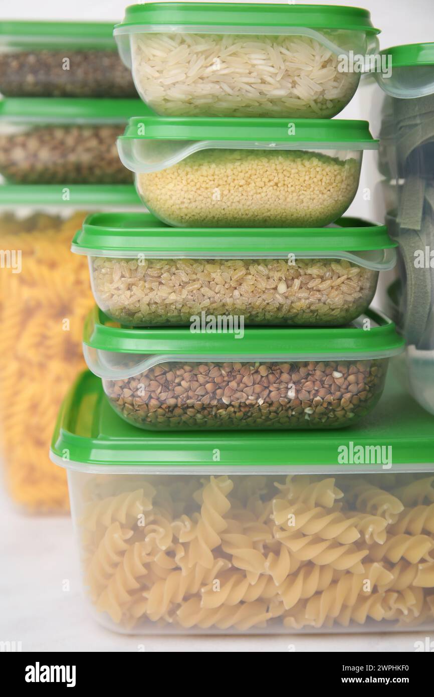 Plastic containers filled with food products on white table Stock Photo ...