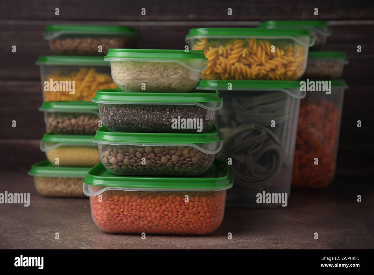 Plastic containers filled with food products on brown table Stock Photo ...