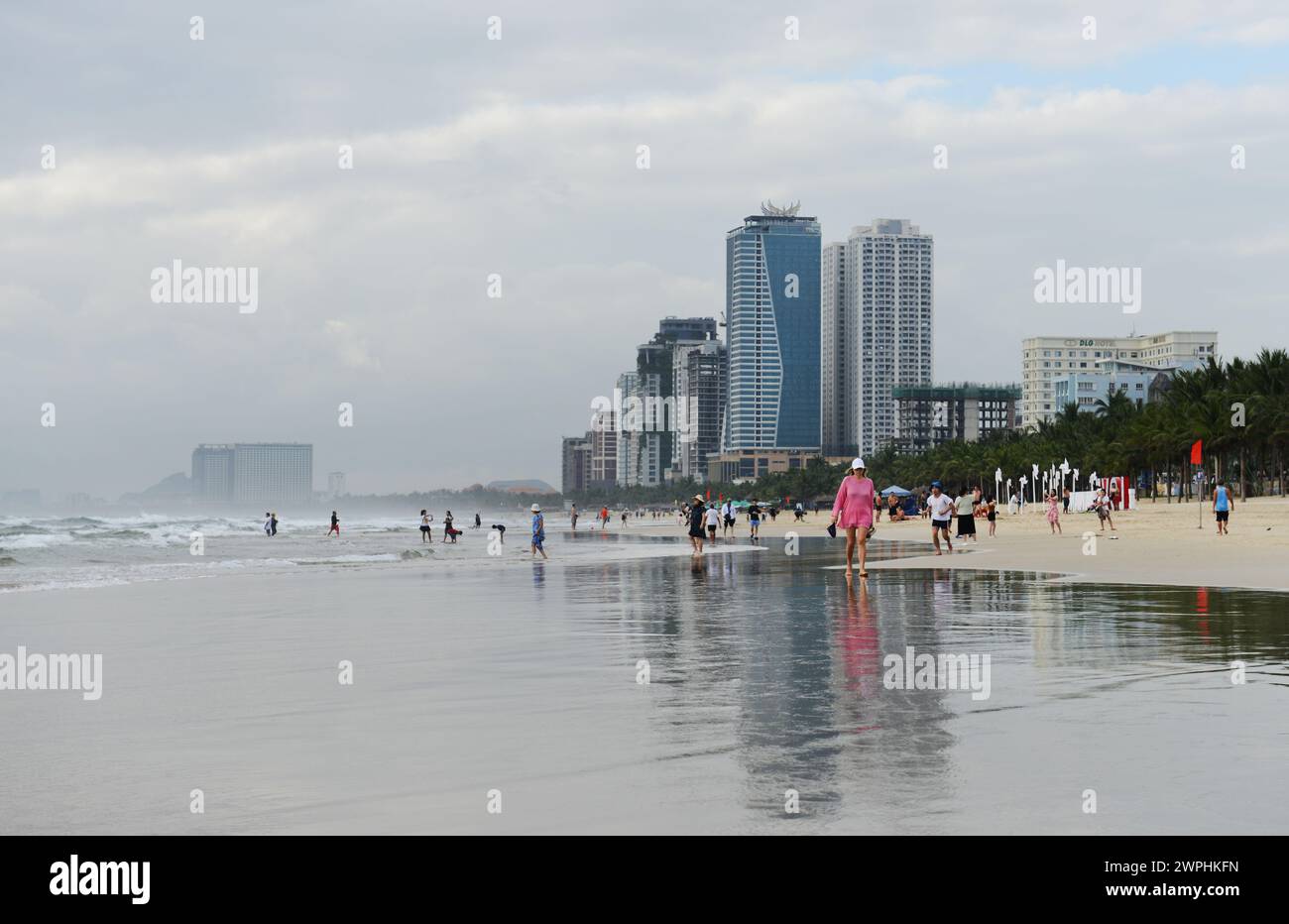 The beautiful long white sand beach along the changing waterfront ...