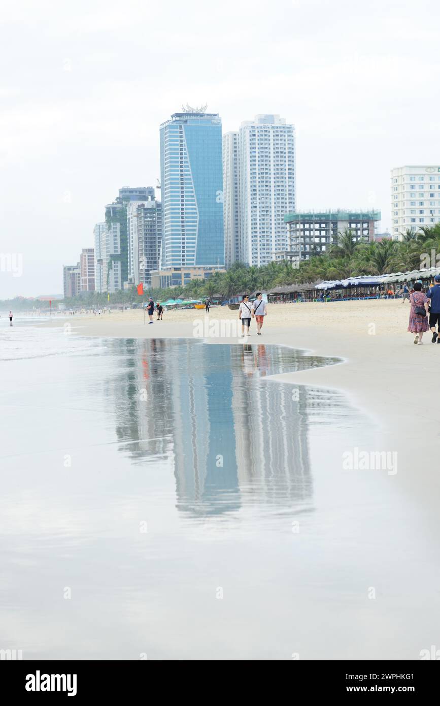 The beautiful long white sand beach along the changing waterfront ...