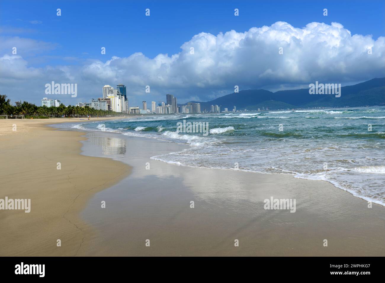 The beautiful long white sand beach along the changing waterfront ...