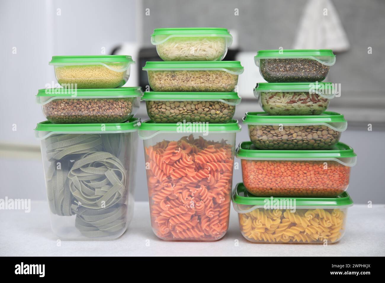 Plastic containers filled with food products on light table indoors ...