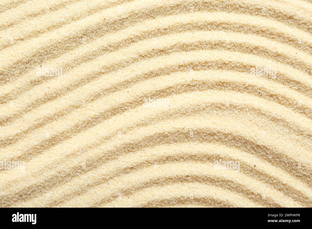 Zen rock garden. Wave pattern on beige sand, top view Stock Photo - Alamy