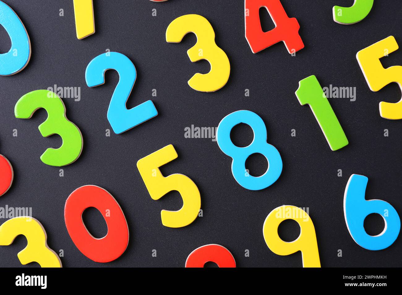 Colorful numbers on black background, flat lay Stock Photo - Alamy