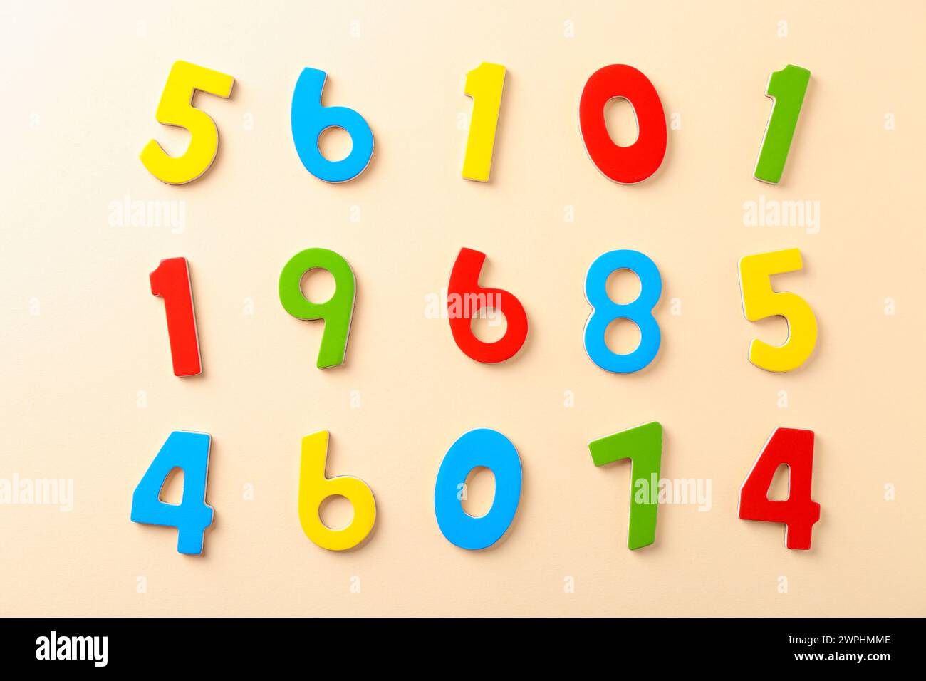 Colorful numbers on beige background, flat lay Stock Photo - Alamy