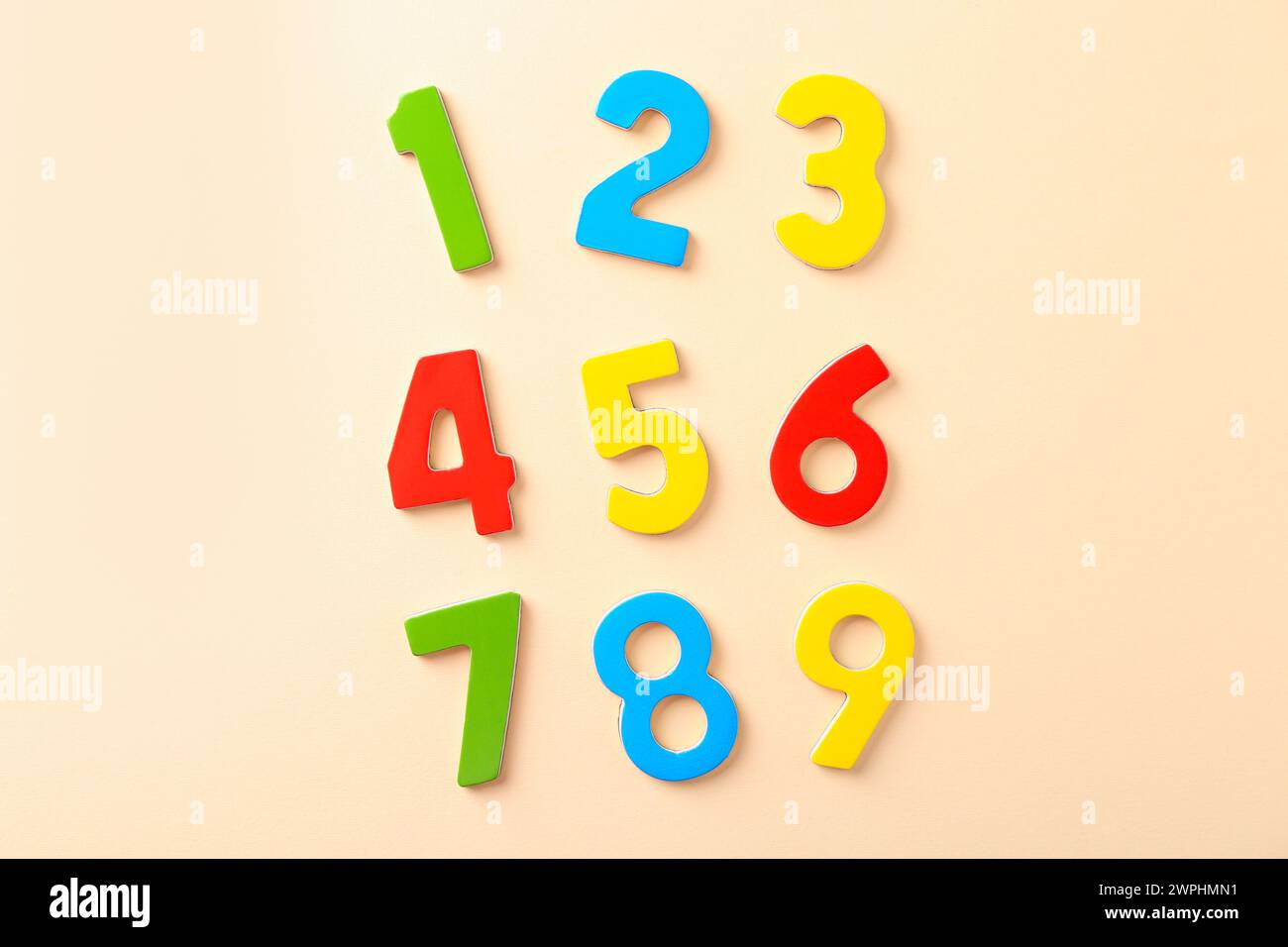 Colorful numbers on beige background, flat lay Stock Photo - Alamy