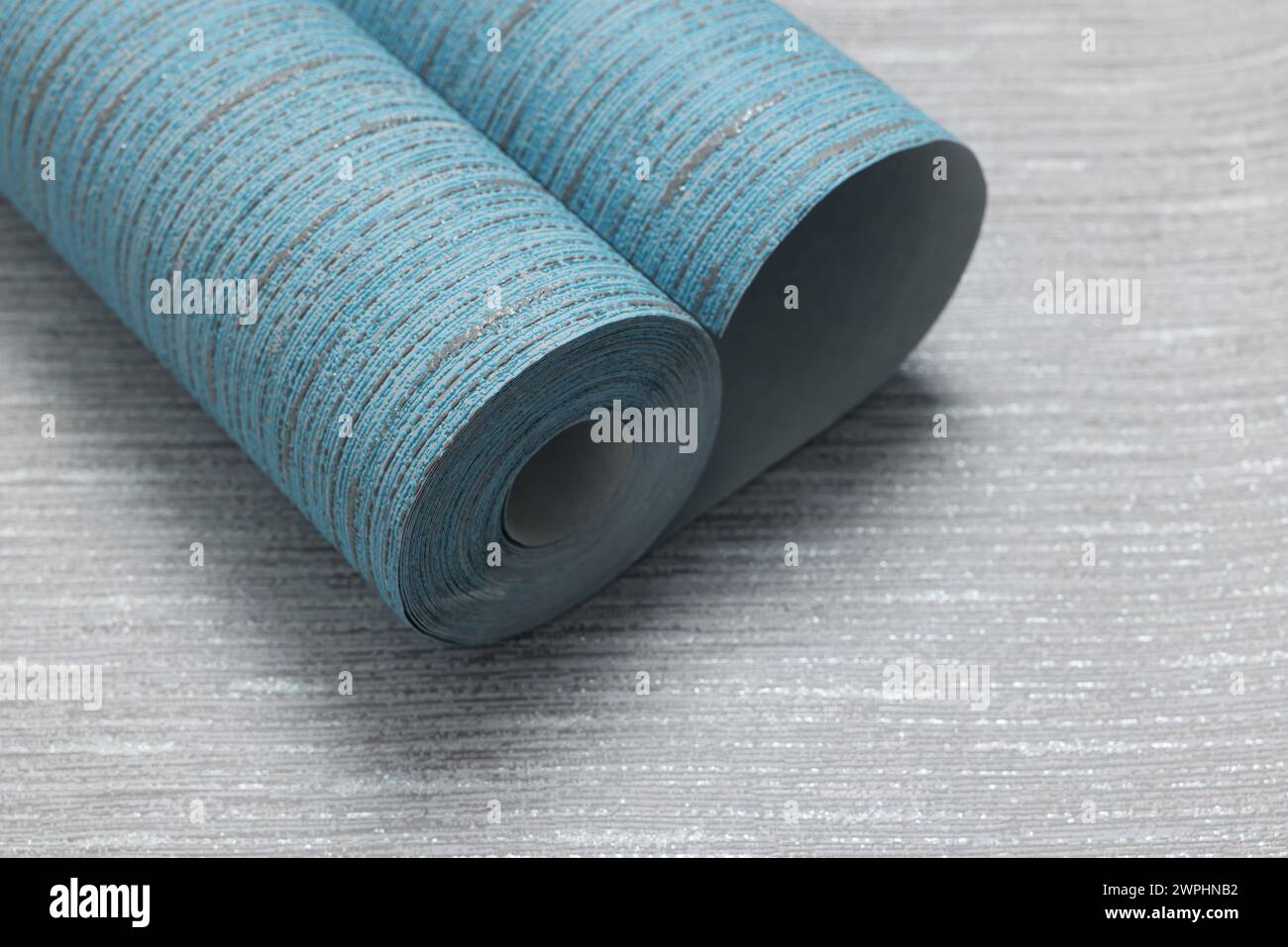 Light blue wallpaper roll on grey sample, space for text Stock Photo ...
