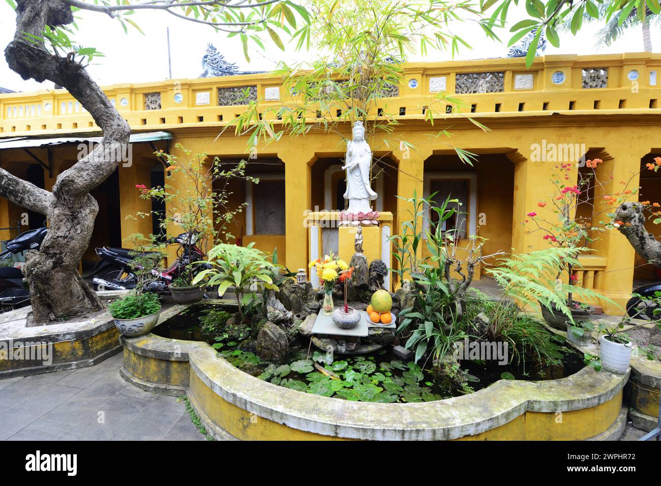 A small garden at a courtyard by the Quan Cong Temple in Hoi An ...