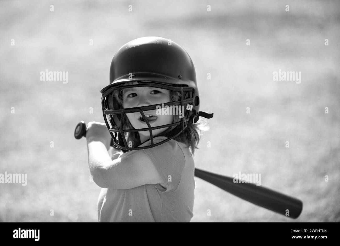 Little child baseball player focused ready to bat. Kid holding a ...